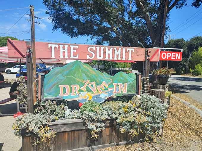 The hand-painted sign welcomes you to Summit Drive In, where elevation meets exceptional burgers and shakes galore.