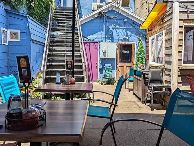 The back patio offers outdoor seating surrounded by quirky charm, perfect for sunny morning meals in fresh air.