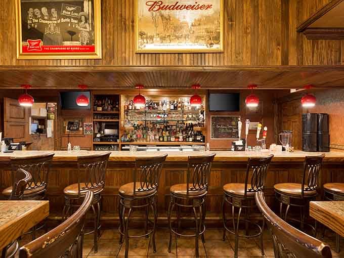 Classic bar setup with red pendant lights and plenty of seating for pre-dinner drinks or nightcaps.