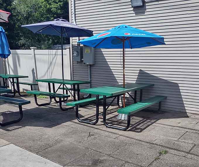 Simple picnic tables under bright umbrellas offer the perfect spot to enjoy your steamed masterpiece on a sunny Connecticut afternoon.