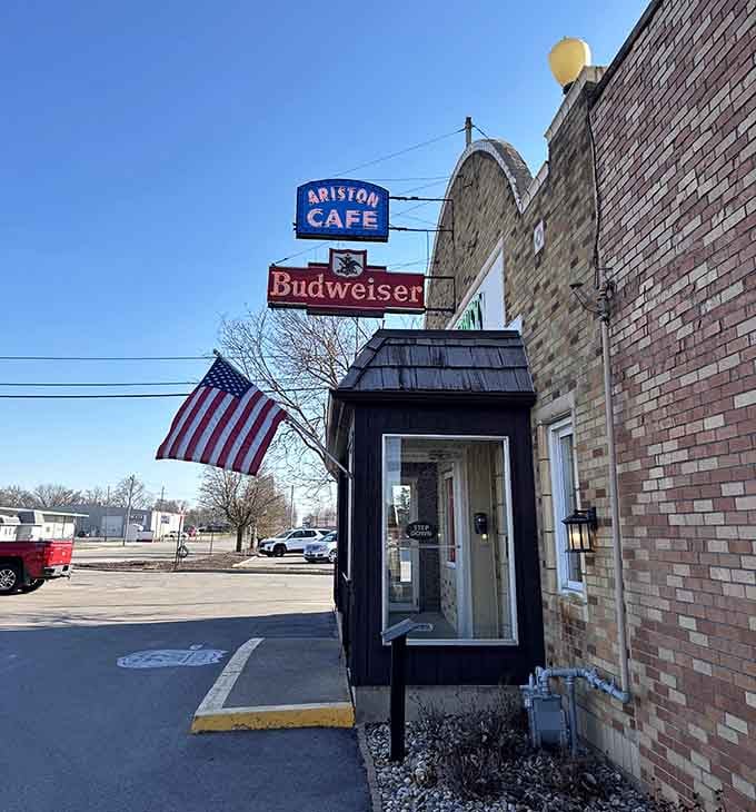 The entrance stands proud with its American flag and vintage signs, beckoning hungry travelers like a delicious lighthouse.