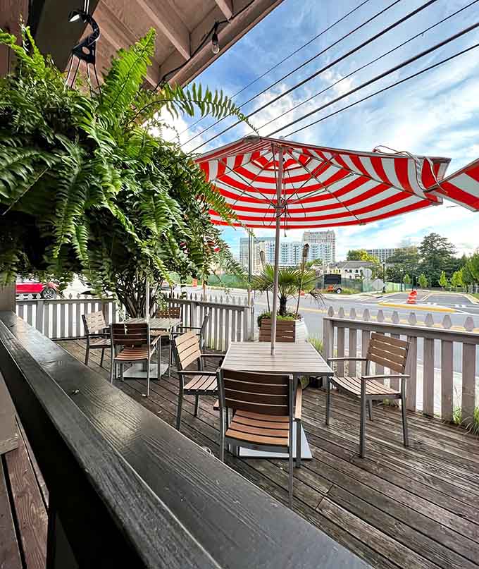 Patio seating under striped umbrellas lets you dine al fresco while Buckhead traffic becomes your ocean soundtrack.