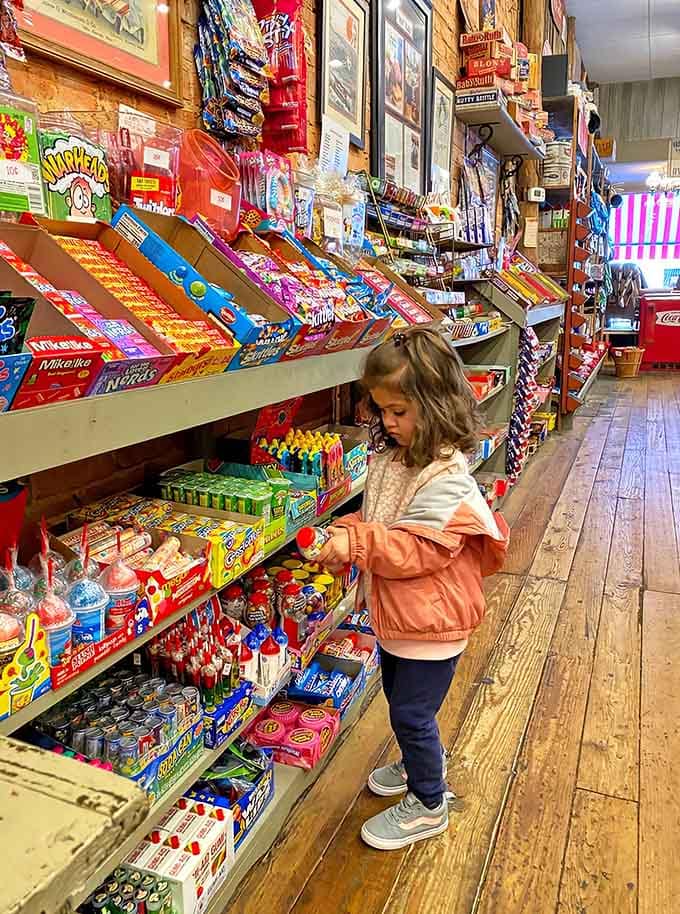 Pure concentration on her face as she weighs life's important decisions: gummy worms or chocolate coins, maybe both?