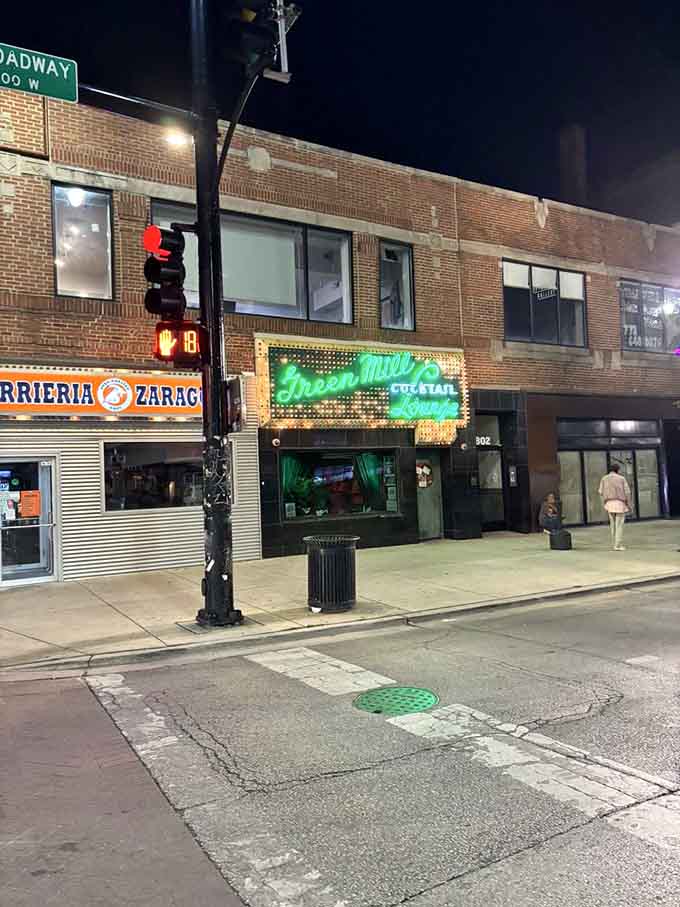 The Green Mill glowing on Broadway at night, a beacon for anyone seeking real jazz and better times.