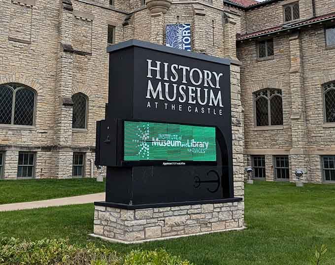Modern digital signage announces current exhibits while the century-old castle walls stand majestically behind it all.