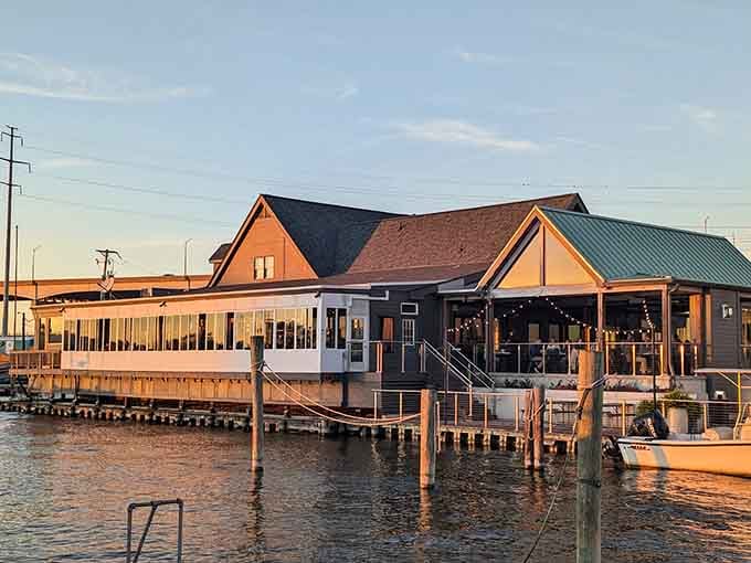 Golden hour light bathes the waterfront restaurant as boats dock nearby, painting the perfect picture of Eastern Shore dining magic.