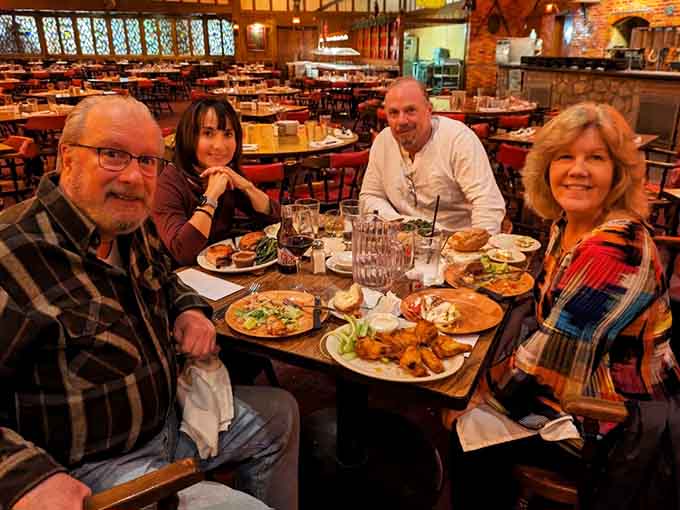 Happy diners enjoying a feast that clearly exceeded expectations, just look at those satisfied smiles there.