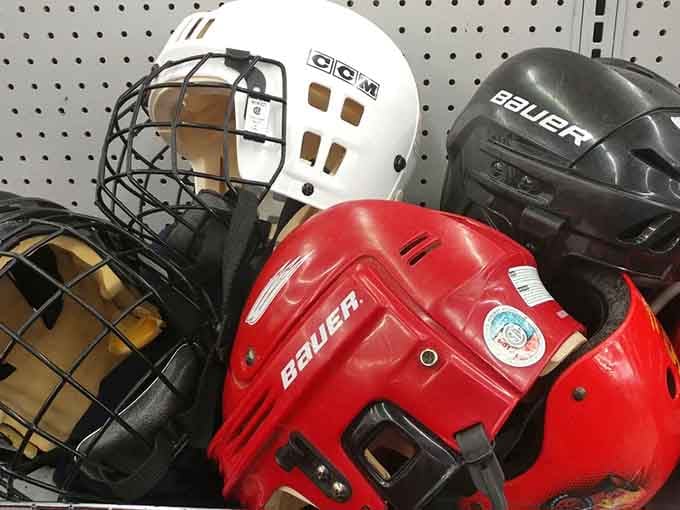 Hockey helmets huddled together like they're planning their next game, protective gear ready for another season.