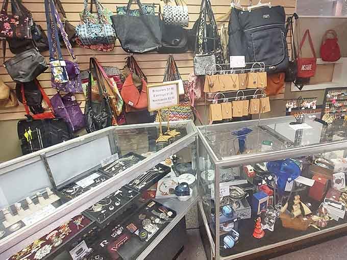 Handbags and jewelry displayed behind glass, because even thrift stores know some treasures deserve extra protection.