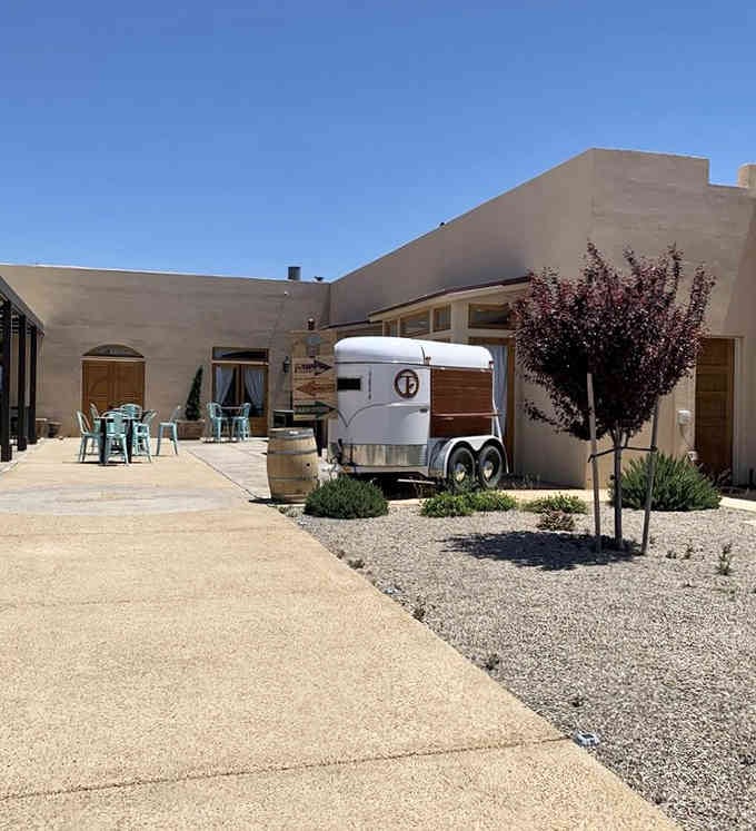 That vintage horse trailer parked outside adds quirky charm to an already photogenic courtyard perfect for lingering.