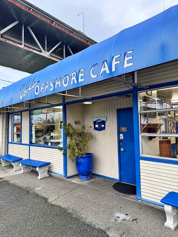 The blue building beckons from beneath the highway, a beacon for anyone seeking breakfast done right.
