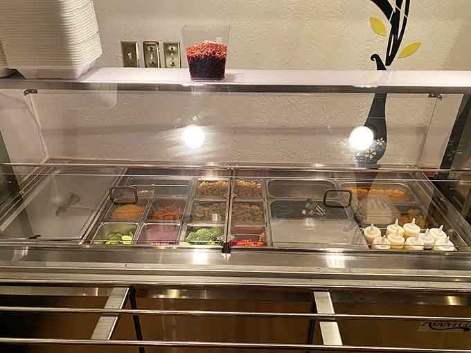 Fresh toppings await their destiny atop golden waffles, like a salad bar that actually makes sense for breakfast lovers.