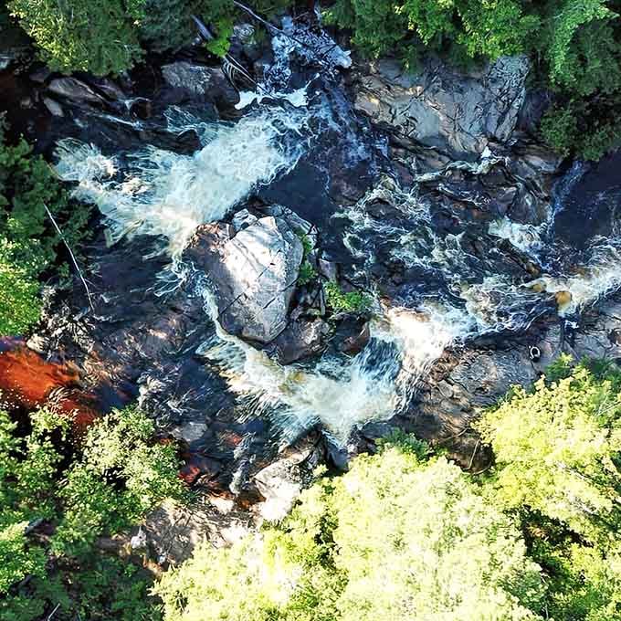 From above, the falls reveal their secret geometry, water carving patterns into rock like nature's own abstract painting.