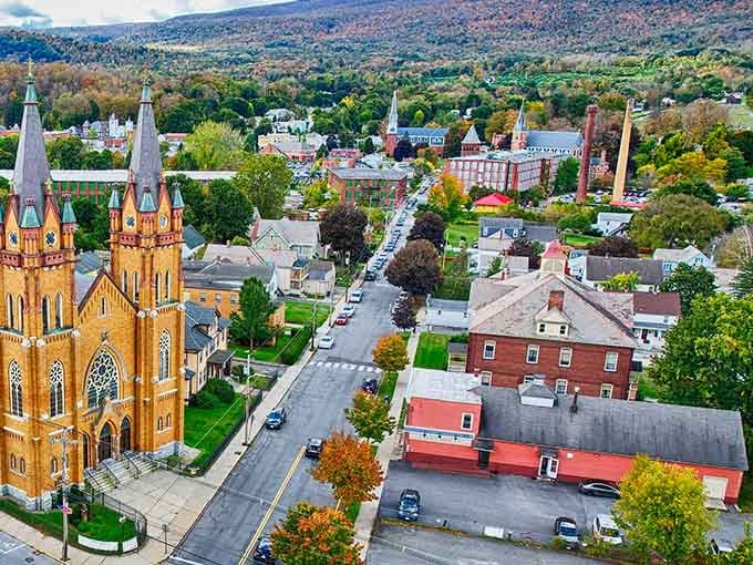 Church spires pierce the autumn sky while mountains cradle this Berkshire gem in nature's colorful embrace.