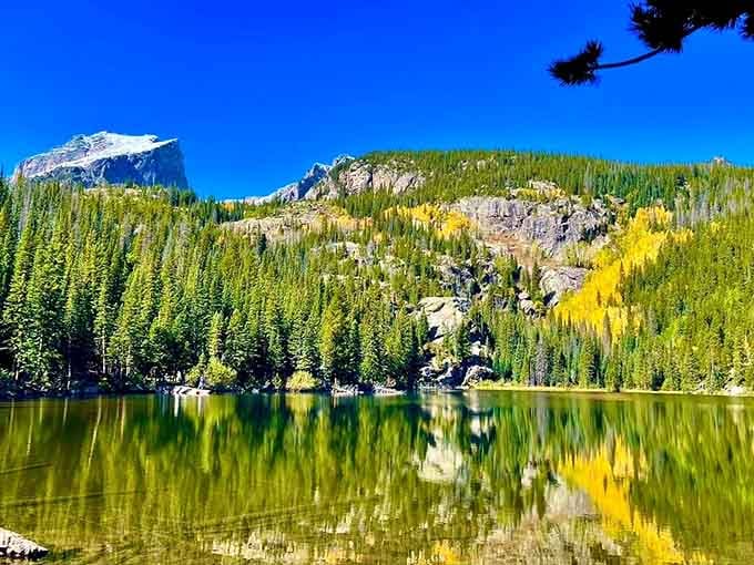 That mirror-perfect reflection turns Bear Lake into nature's own kaleidoscope, doubling your mountain views for free.