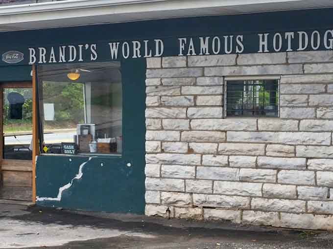 That classic stone facade and walk-up window whisper promises of perfectly grilled hot dogs worth every single bite.