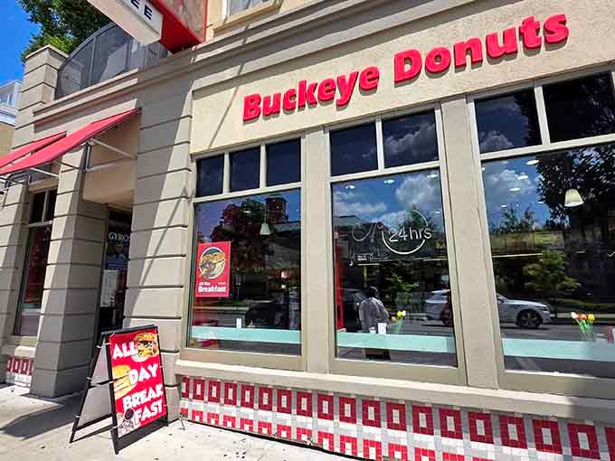 That bold red signage practically shouts "fresh donuts here!" and those big windows let you watch the magic happen.