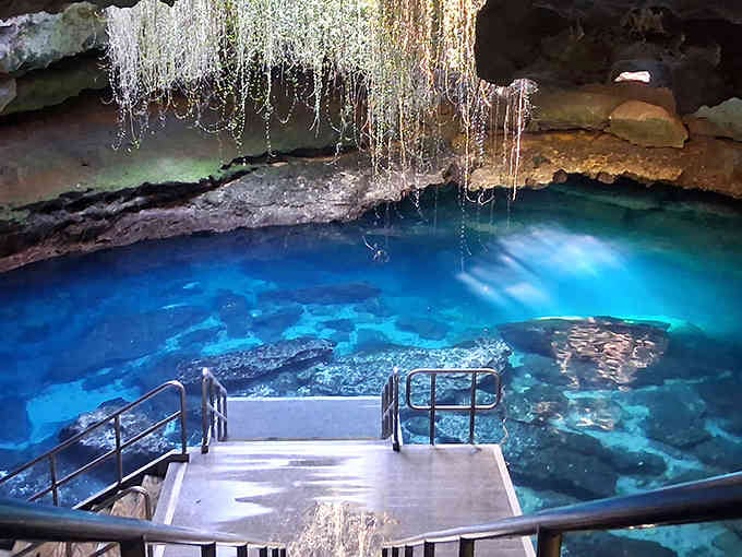 That turquoise water glowing inside an ancient cave looks like something from a fantasy movie come to life.