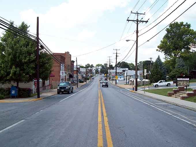Power lines crisscross above a street that's seen generations pass, each one discovering the same welcoming small-town spirit.