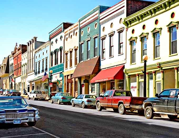 Look at those colorful storefronts standing shoulder to shoulder like they've been best friends since the 1800s!