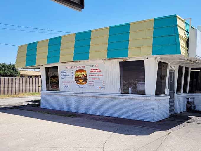 Those teal and yellow stripes are like a beacon calling you to burger paradise under sunny skies.