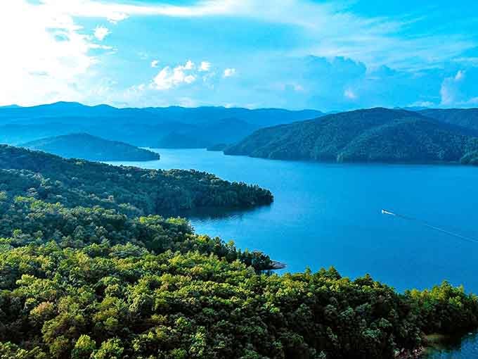 That blue water looks like someone liquified the sky and poured it between mountains that go on forever.