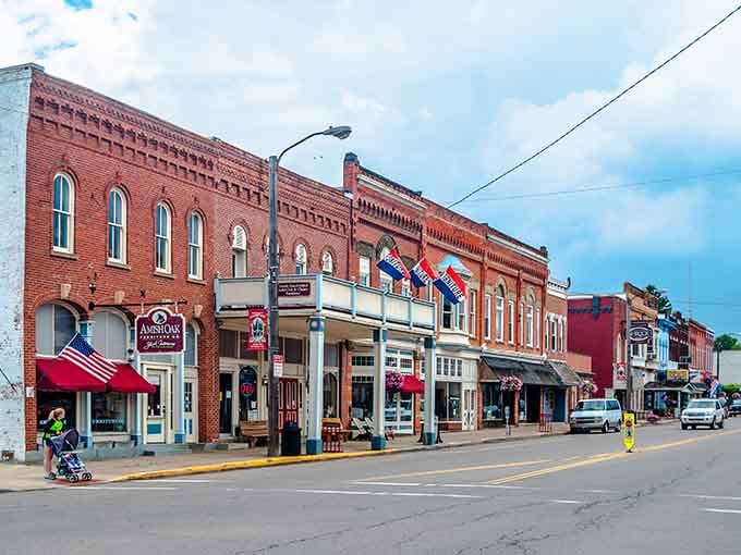 Red brick storefronts and patriotic flags create a Main Street that looks like it stepped out of a Norman Rockwell painting.