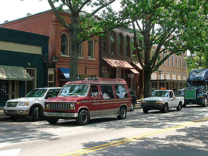 Classic cars and brick storefronts create a scene straight from a Norman Rockwell painting come to life.