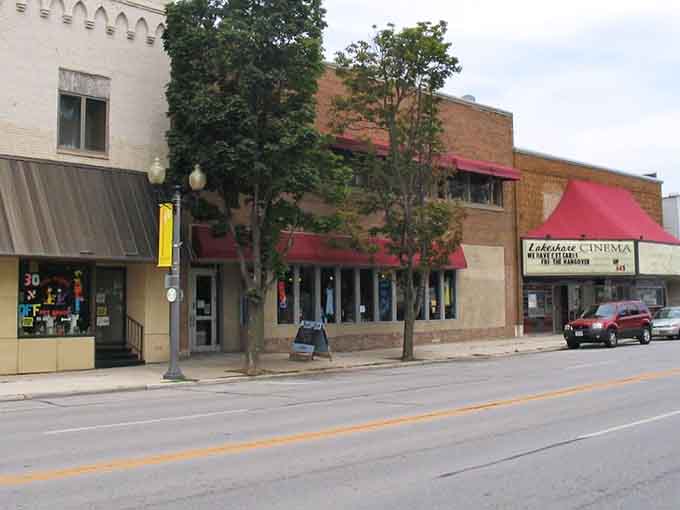 Classic storefronts with red awnings line this charming street where neighbors still greet each other by name.