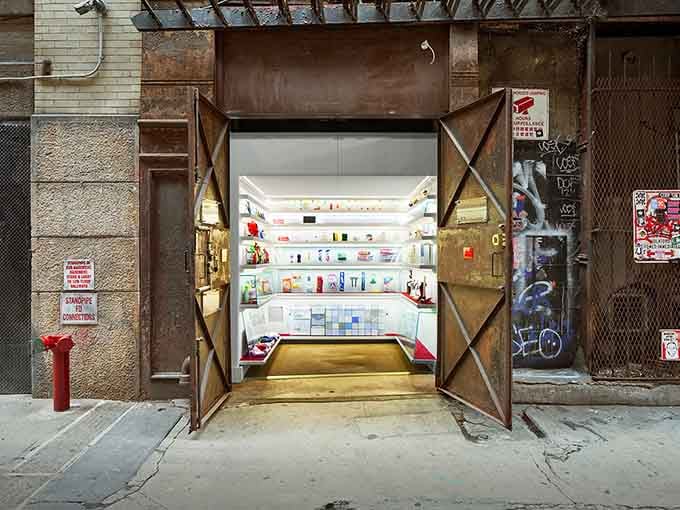 Behind those industrial doors lies the world's tiniest museum, glowing like a jewel box in an alley.