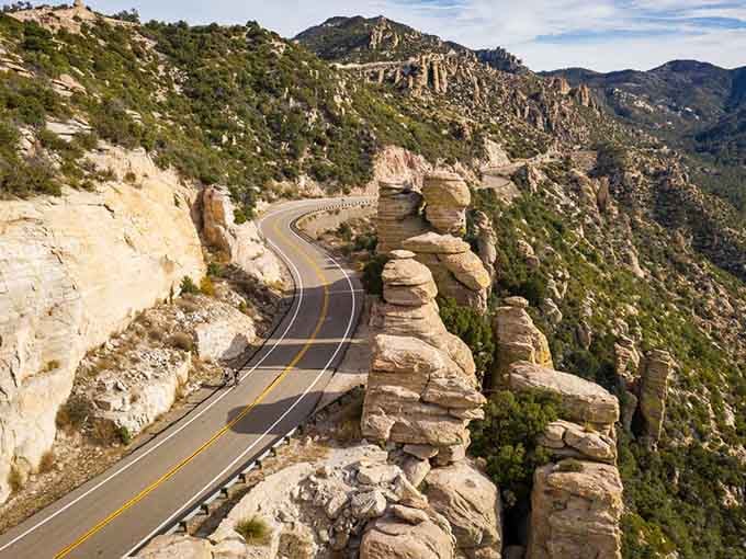 Those rock formations standing like ancient sentinels make every hairpin turn feel like a scene from a Western epic.