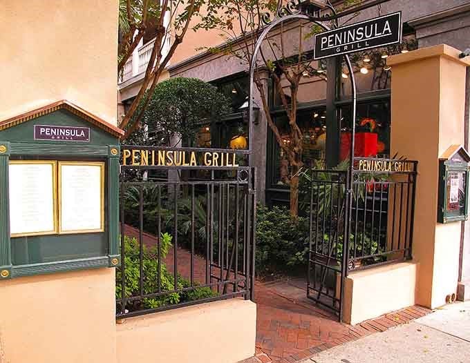 Those iron gates open to a secret garden courtyard where trees grow through the dining space like nature's chandeliers.