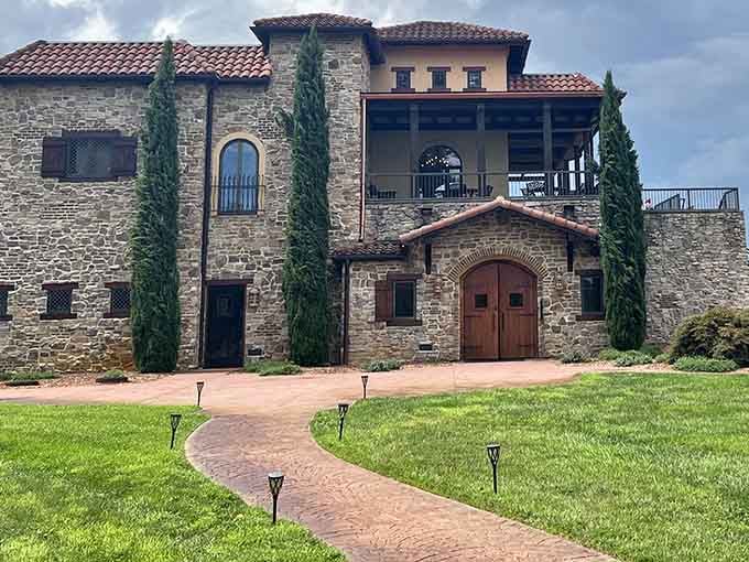 Tuscany called and said you can keep this one – those stone walls and cypress trees are pure Italian magic.