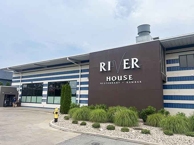 Those nautical blue stripes promise fresh catches inside, where the raw bar serves oysters that taste like the ocean.