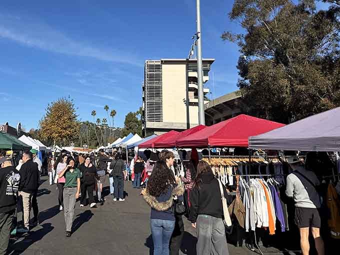 Colorful tents stretch endlessly beneath blue skies where treasure hunters gather for their monthly ritual of discovery.