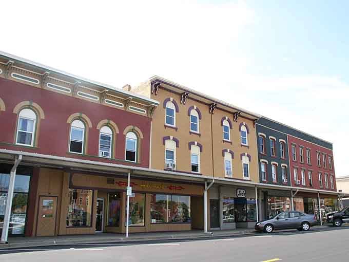 These historic storefronts wear their age like badges of honor, standing proud in colorful brick rows.