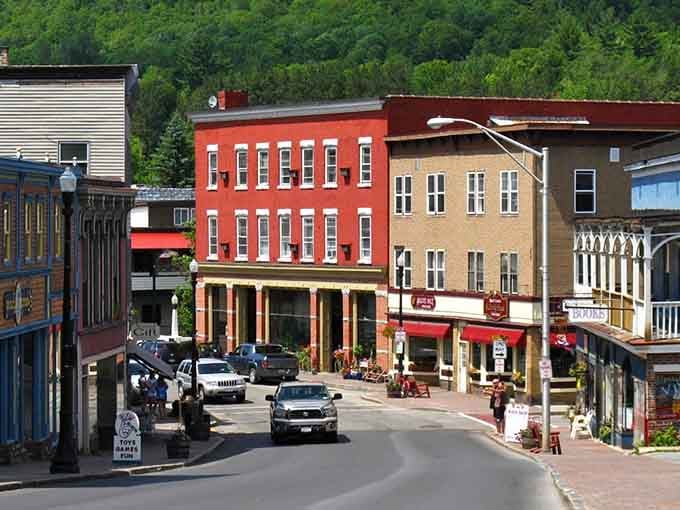 That bold red building against the mountain backdrop makes this Adirondack street look like a movie set.