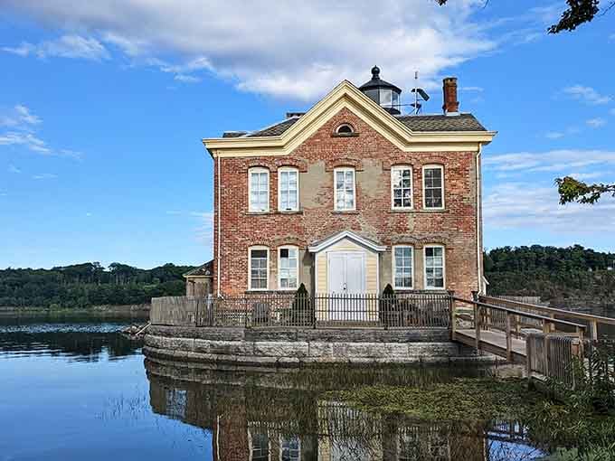 This brick beauty sits on the water like a postcard from another era, perfectly mirrored in the glassy Hudson River.