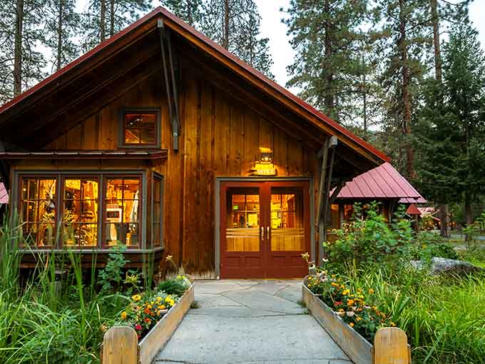 Golden light spills from every window of this mountain retreat, promising warmth and wonder among the towering pines.