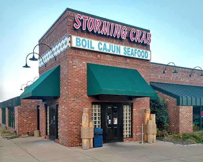 That brick facade and green awning promise one thing: serious Cajun seafood without the pretense or fuss.