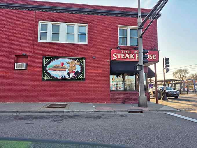 That classic red brick corner building holds serious steak secrets behind those vintage windows and charming signage.