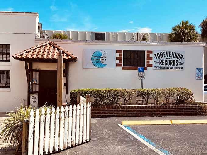 That white picket fence and Spanish tile roof make vinyl hunting feel like a Mediterranean vacation right here.