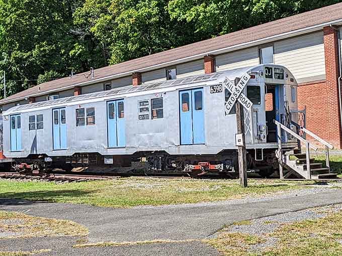 This vintage trolley car with its classic railroad crossing sign brings back memories of simpler times.