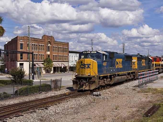 Modern freight trains still rumble past these historic brick buildings, connecting past and present in perfect harmony.