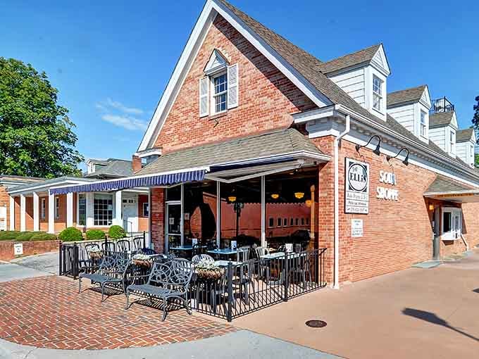 That brick patio with wrought-iron chairs practically begs you to sit down and stay for another round of coffee.