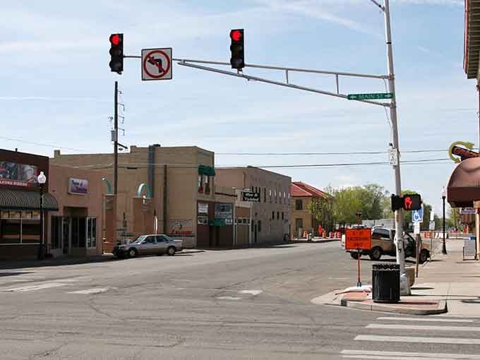This quiet downtown intersection captures small-town life where traffic jams mean waiting for one car to pass.