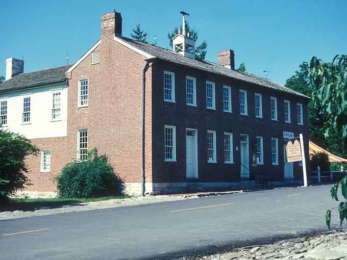This Federal-style building stands solid as a handshake, its dark brick walls holding centuries of Missouri River history.