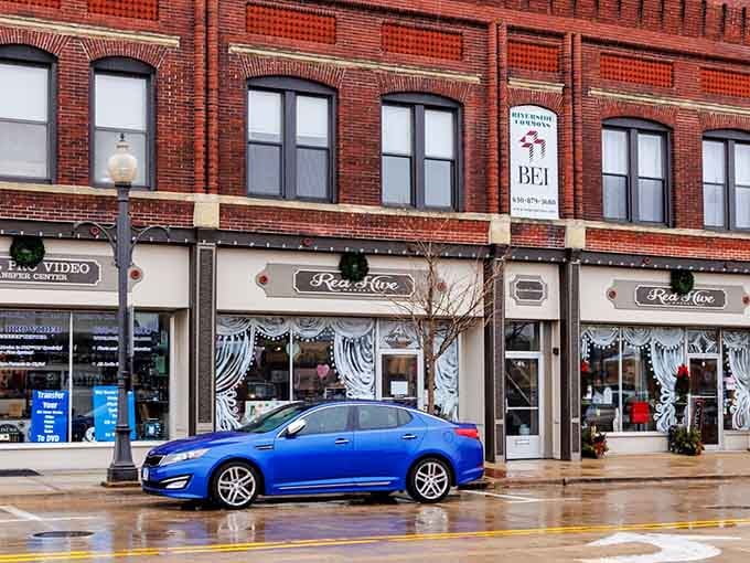 Red brick buildings stand proud on wet streets, their reflections doubling the charm of this riverside gem.