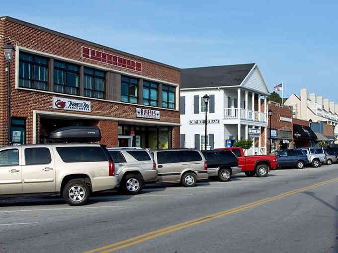 Brick storefronts and white columns create the perfect backdrop for a leisurely stroll through maritime history.
