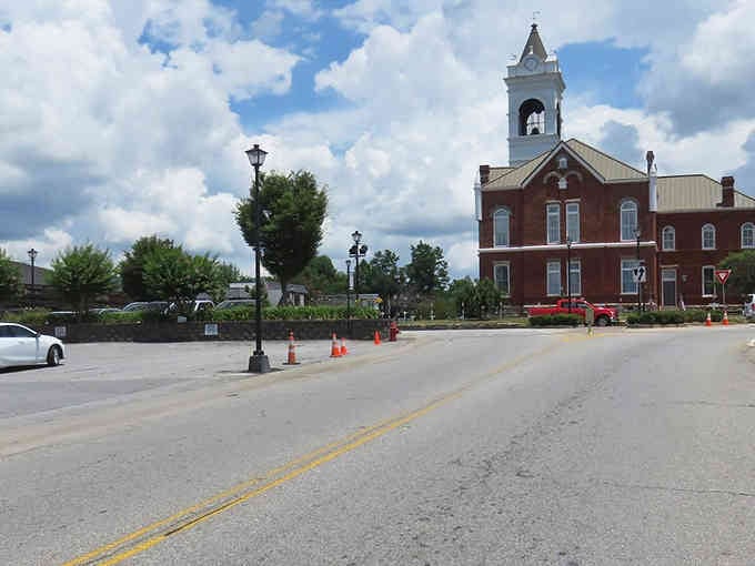 Like a scene from a movie, this courthouse stands tall with timeless red brick and a majestic white tower.